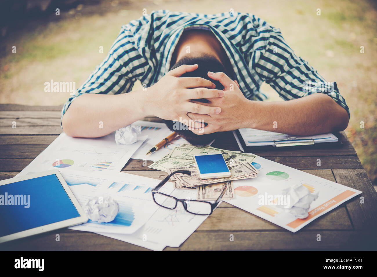 Tired working man sleeping at the workplace full of work Stock Photo ...