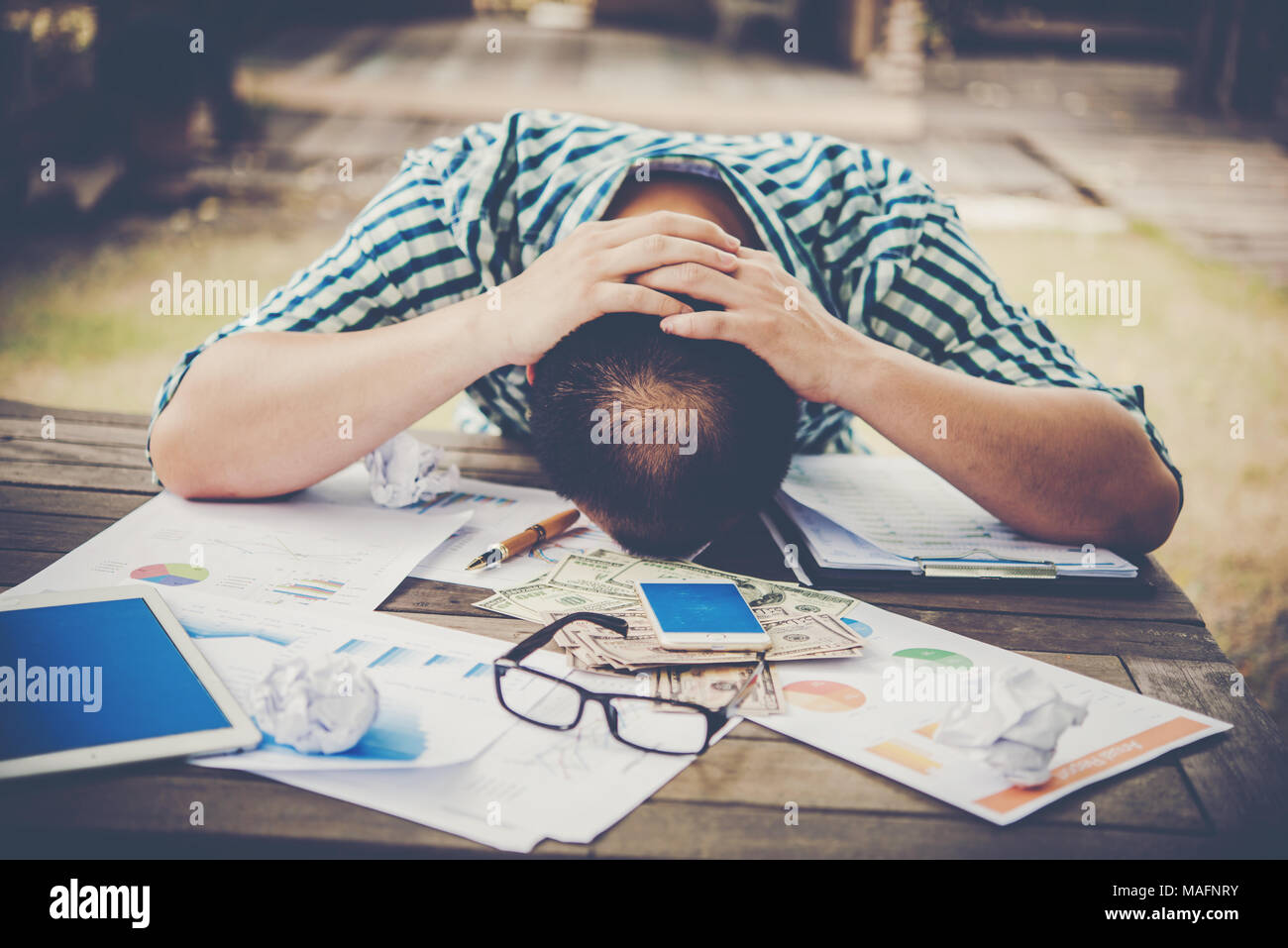 Tired working man sleeping at the workplace full of work Stock Photo ...