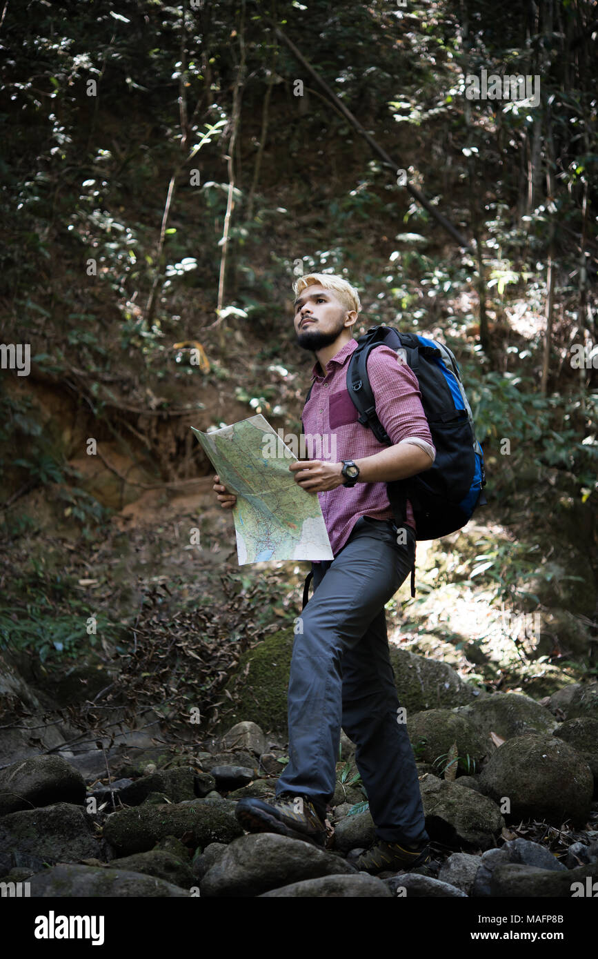 Adventure man observing map hi-res stock photography and images - Alamy