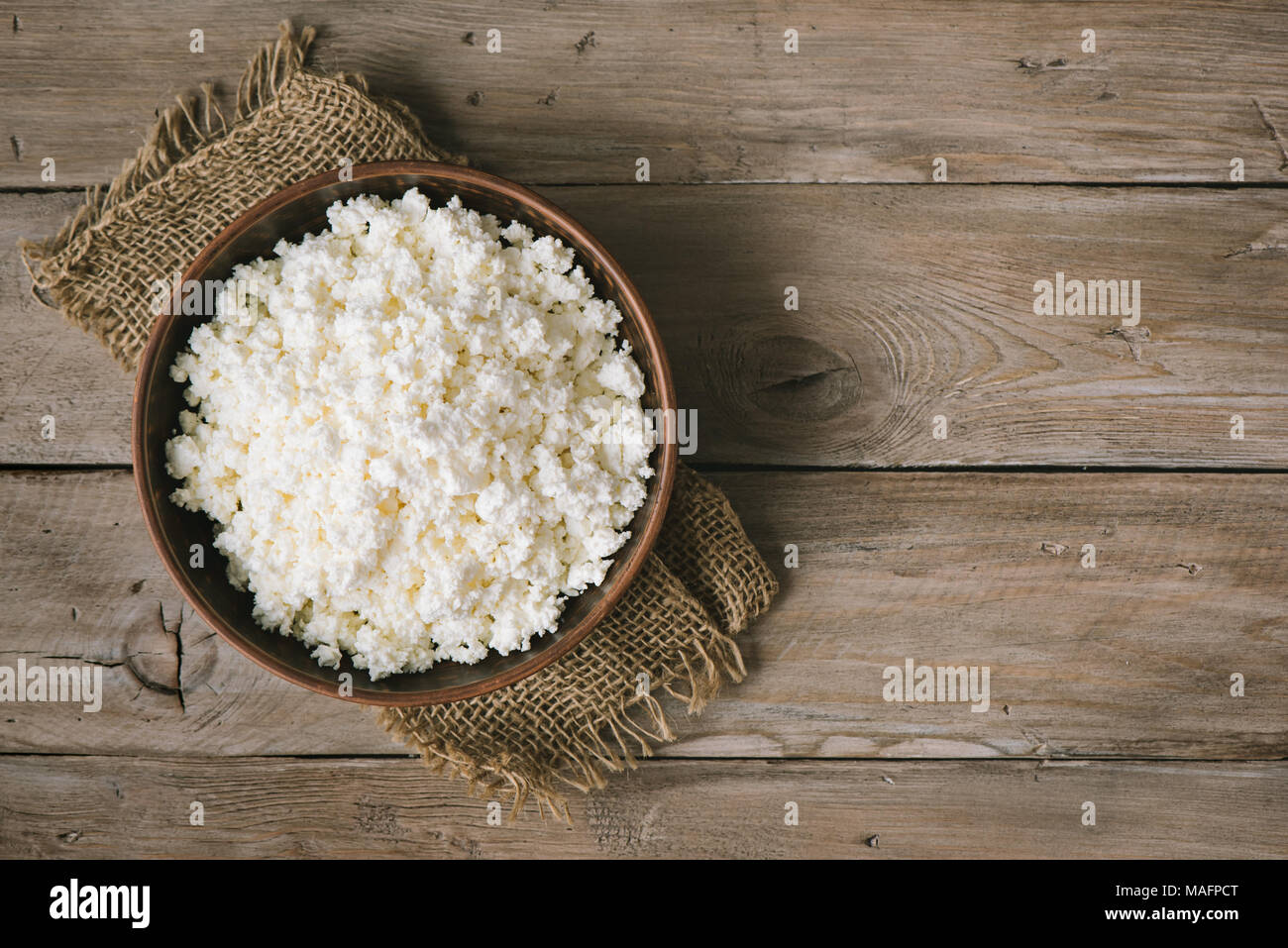 Cottage cheese, curd on rustic wooden table, top view, copy space ...