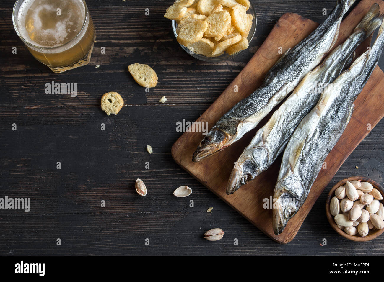 Assorted snacks for beer: sun dried fish, nuts, salted croutons or ...