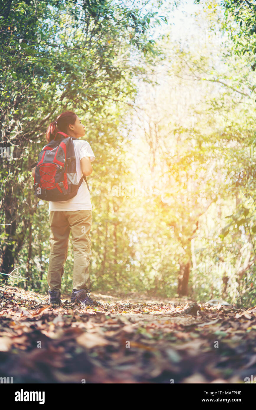 Active young woman hiker walking though the forest enjoy with nature ...