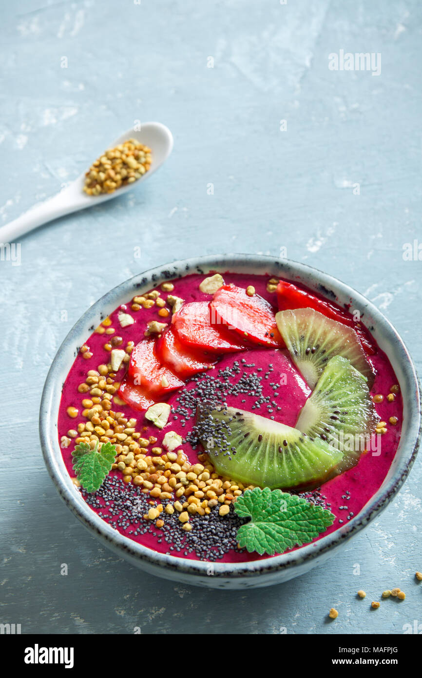Acai smoothie bowl with chia seeds, fruits, berries (strawberries) and ...