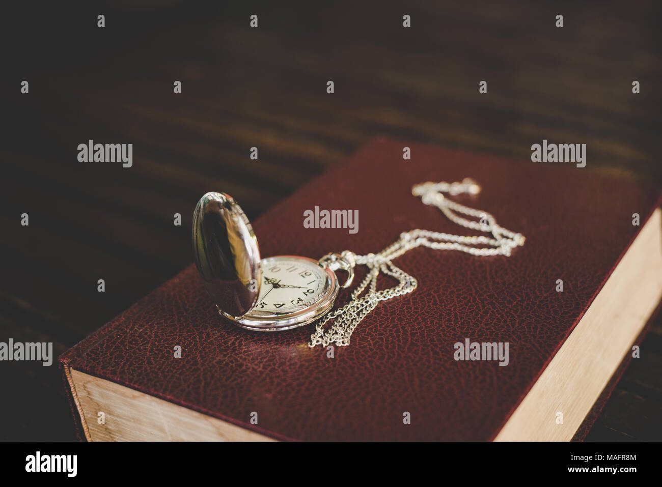 Close up of vintage pocket watch on old books Stock Photo - Alamy