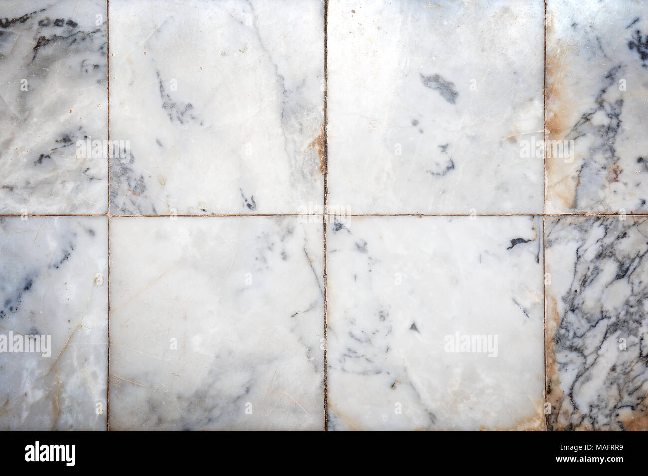 Close-up of worn smooth natural marble tiles texture background with ...