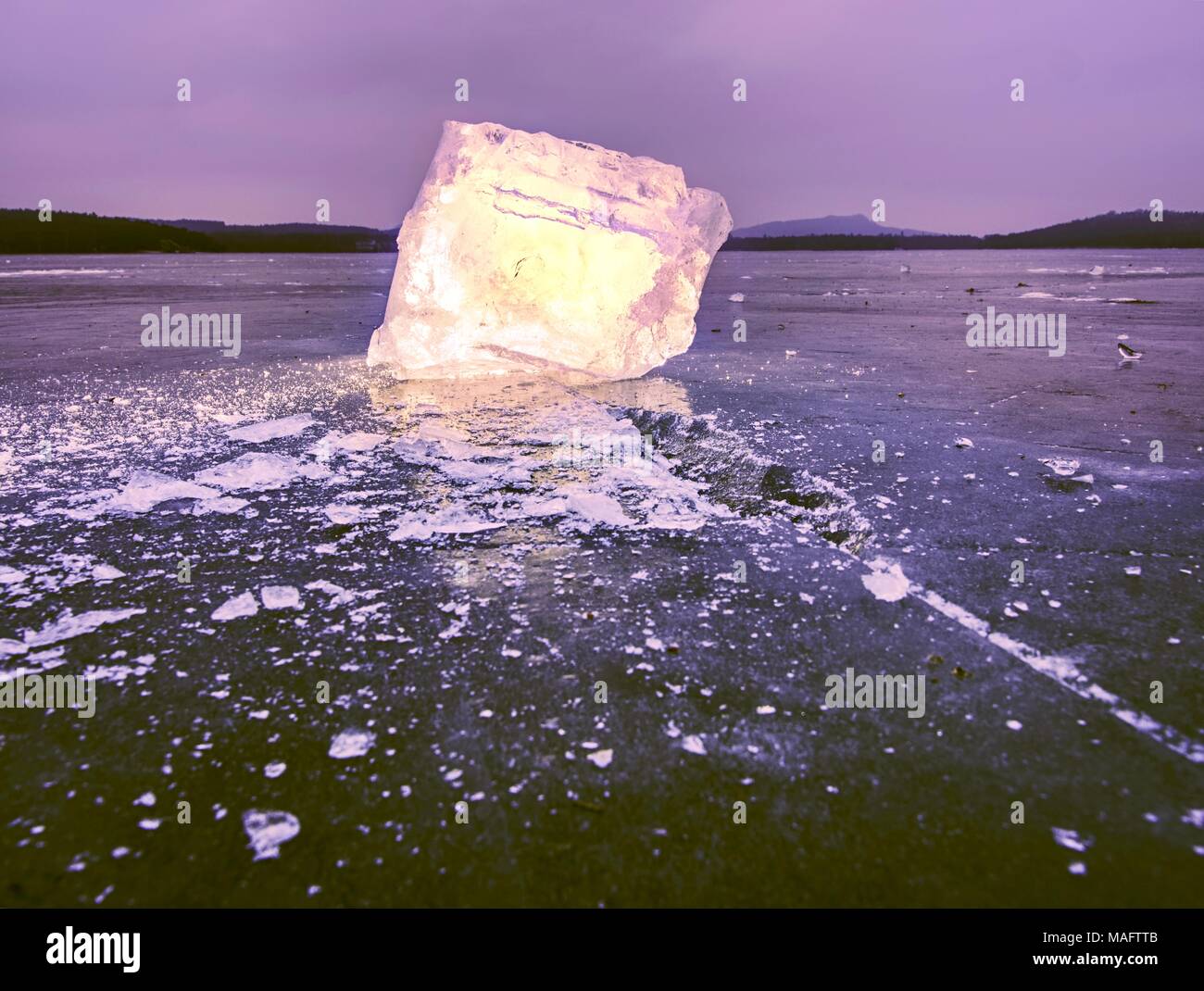 Ice floe and crushed ice on dark frozen and flat ground. Shining ...