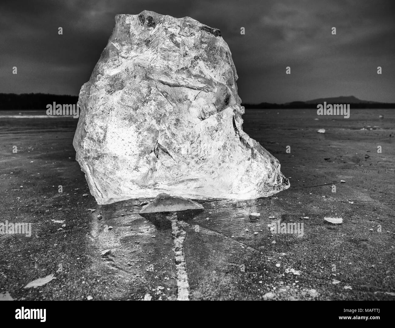 Ice floe and crushed ice on dark frozen and flat ground. Shining ...