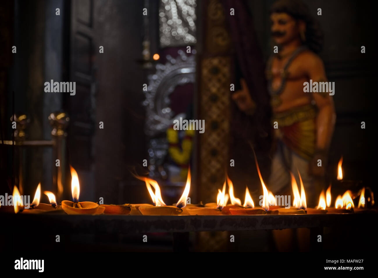 Inside Batu caves in Kuala Lumpur - flame of oil ritual sacred candles ...