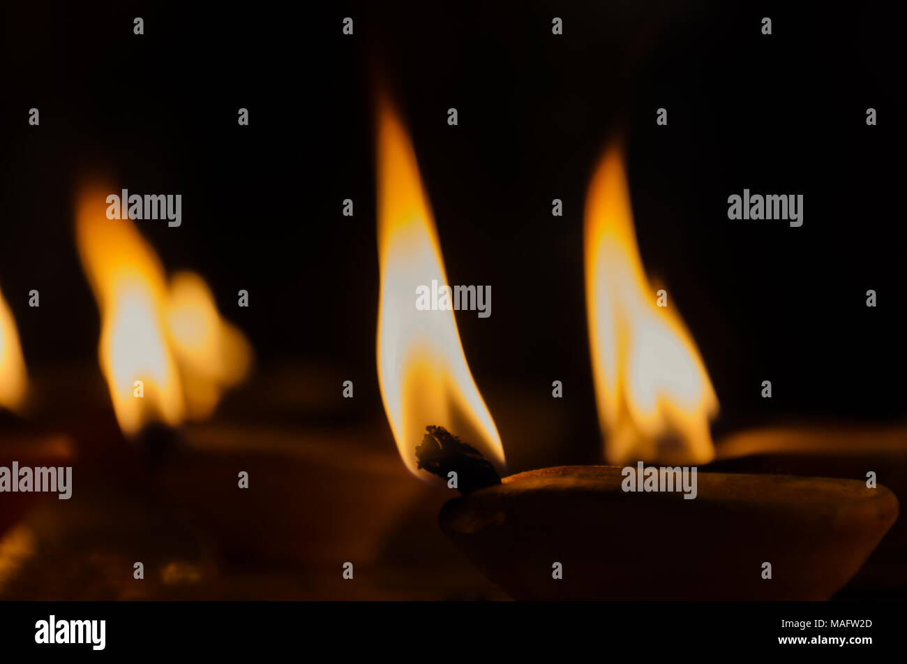 Sacred fire - oil candles inside Hindu temple Stock Photo - Alamy