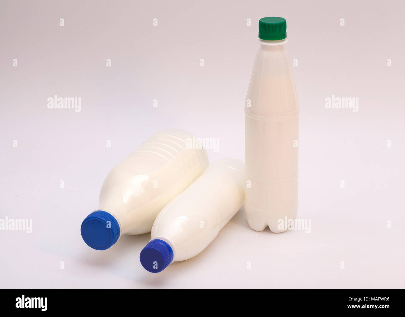 Plastic Bottles of milk isolated on white background Stock Photo - Alamy