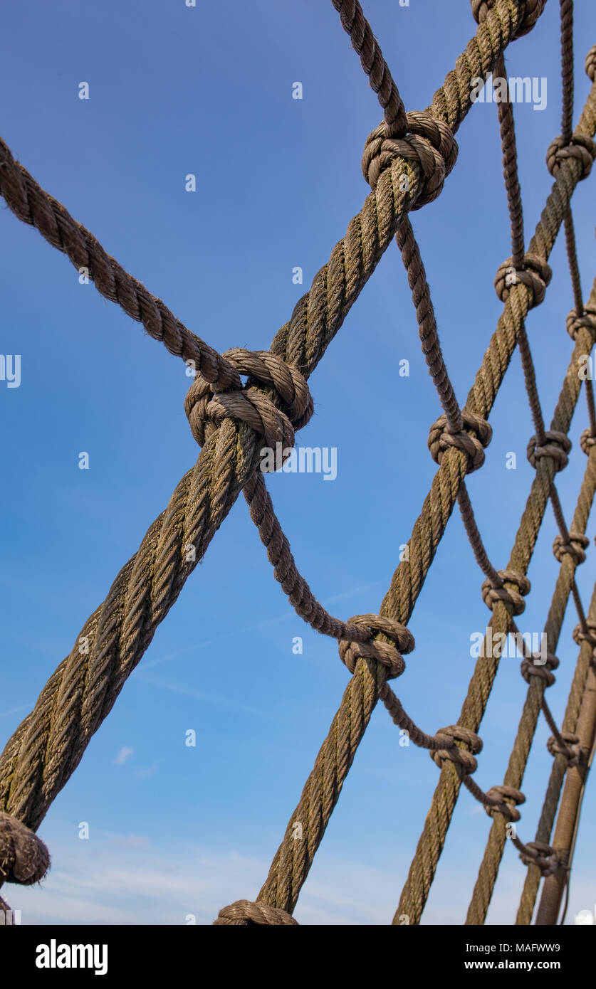 Ropes, pulley, shroud - parts of an old ship, sailboat. Blue sky in the ...