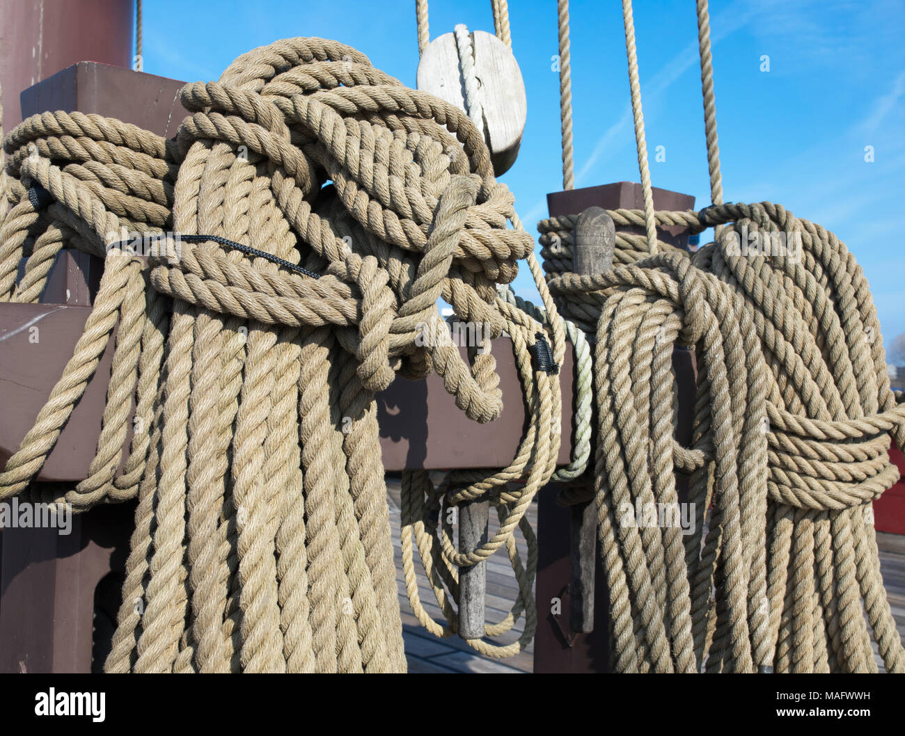 Ropes, pulley, shroud - parts of an old ship, sailboat. Blue sky in the ...