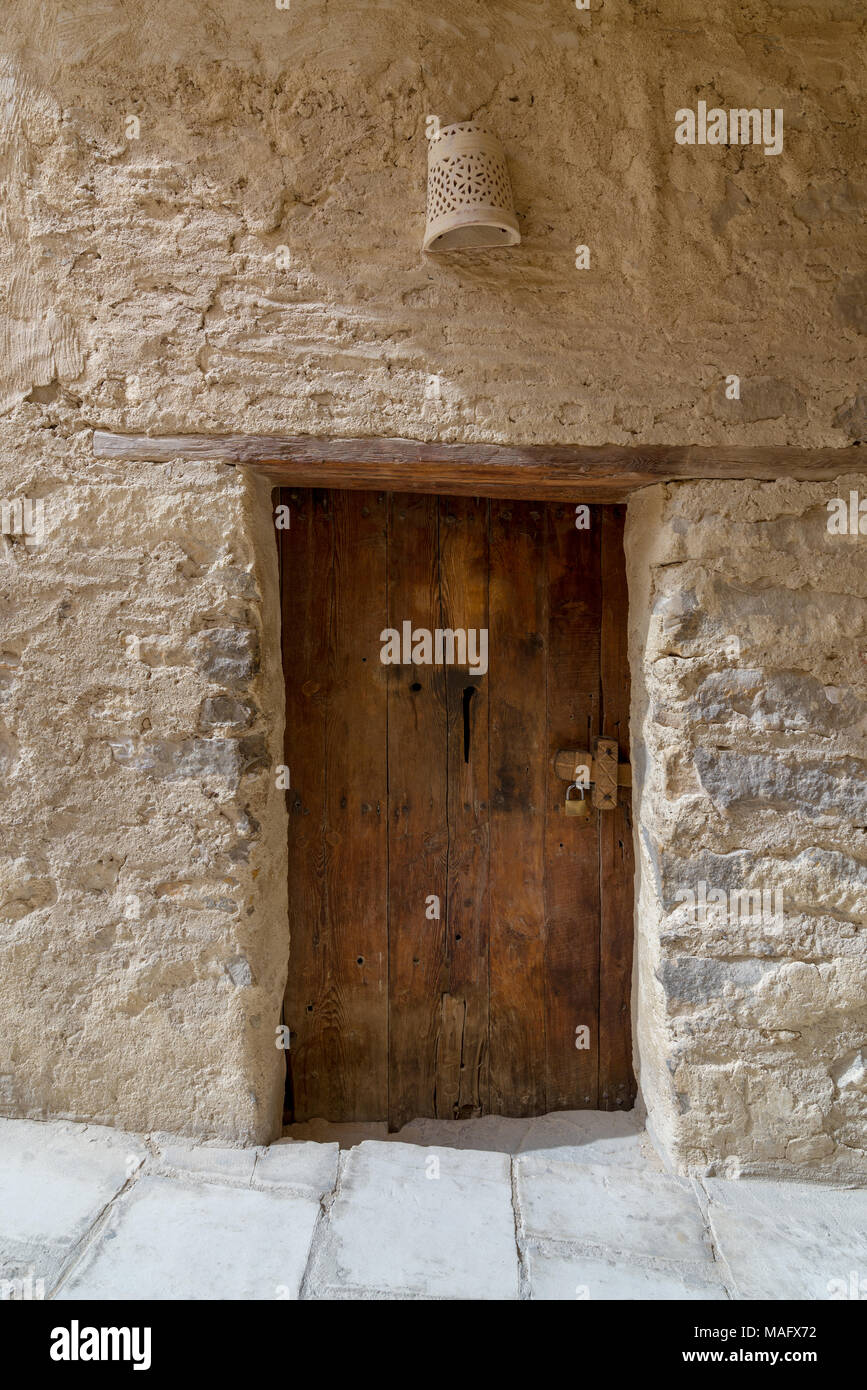 Ancient stone bricks wall and old wooden door at the Monastery of Saint ...