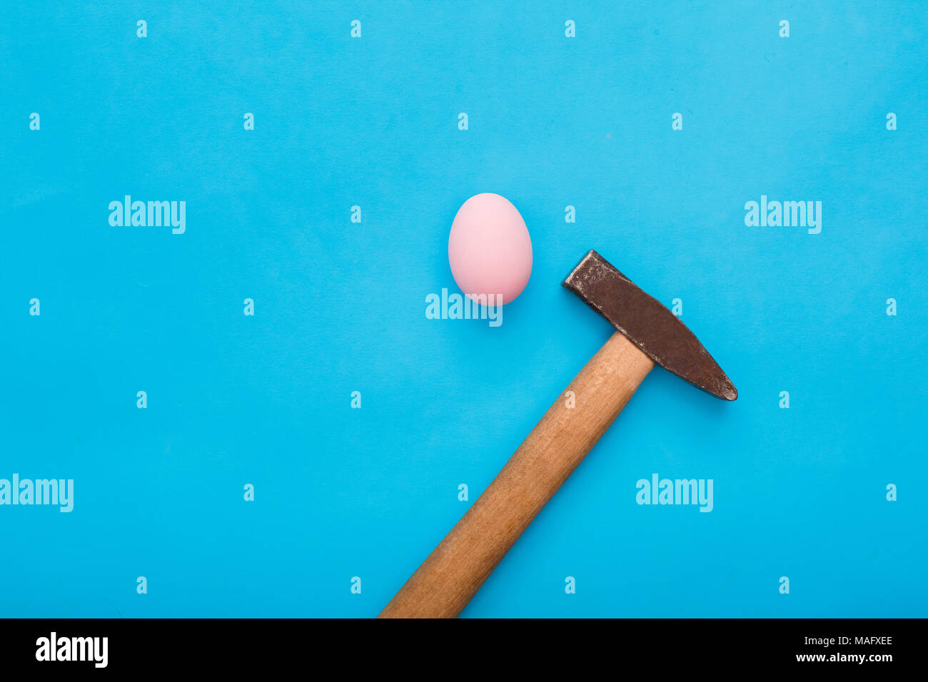 Easter traditional objects isolated on blue background egg and hammer ...