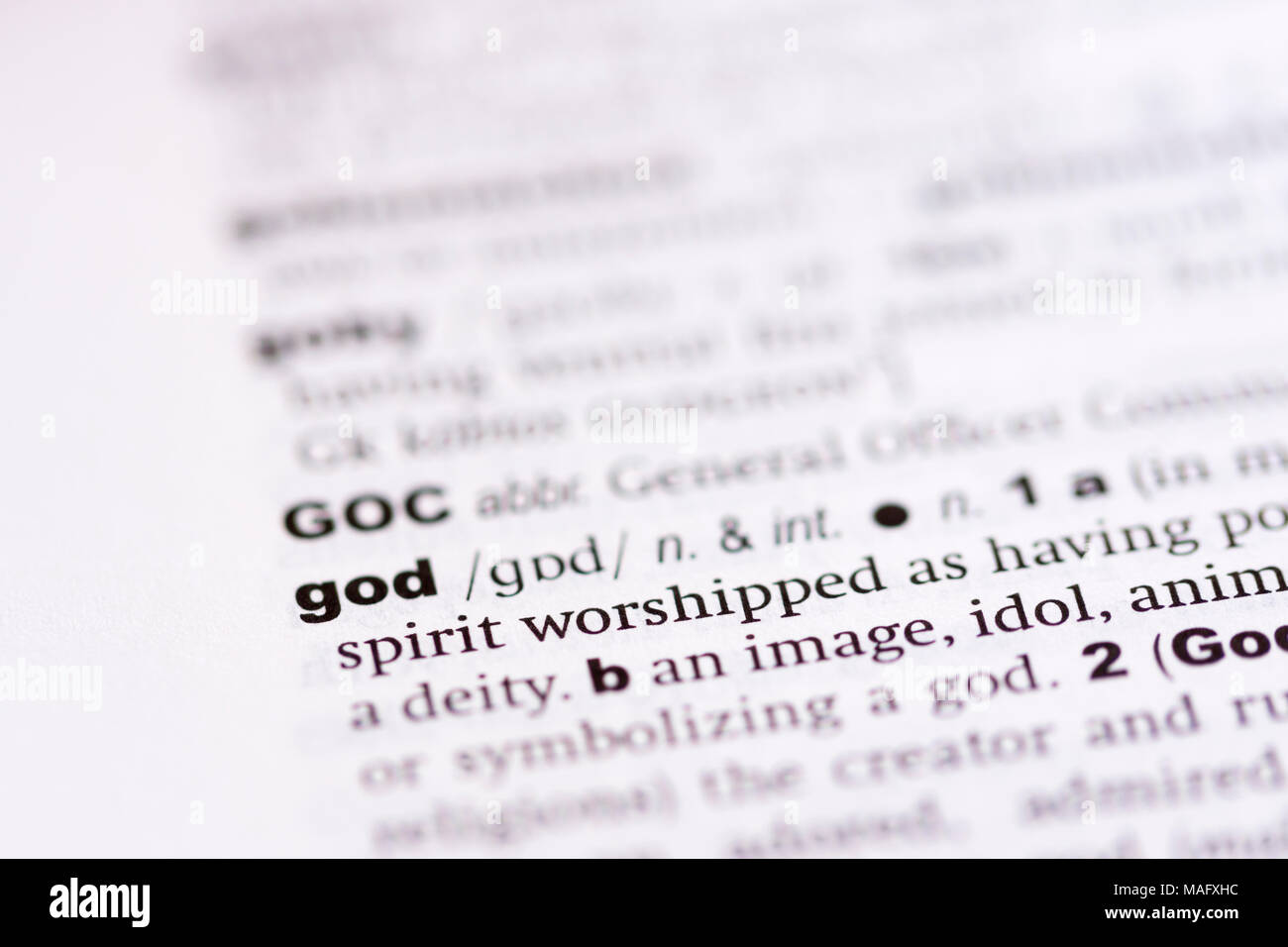 A macro shot showing the definition of the word god in an English ...