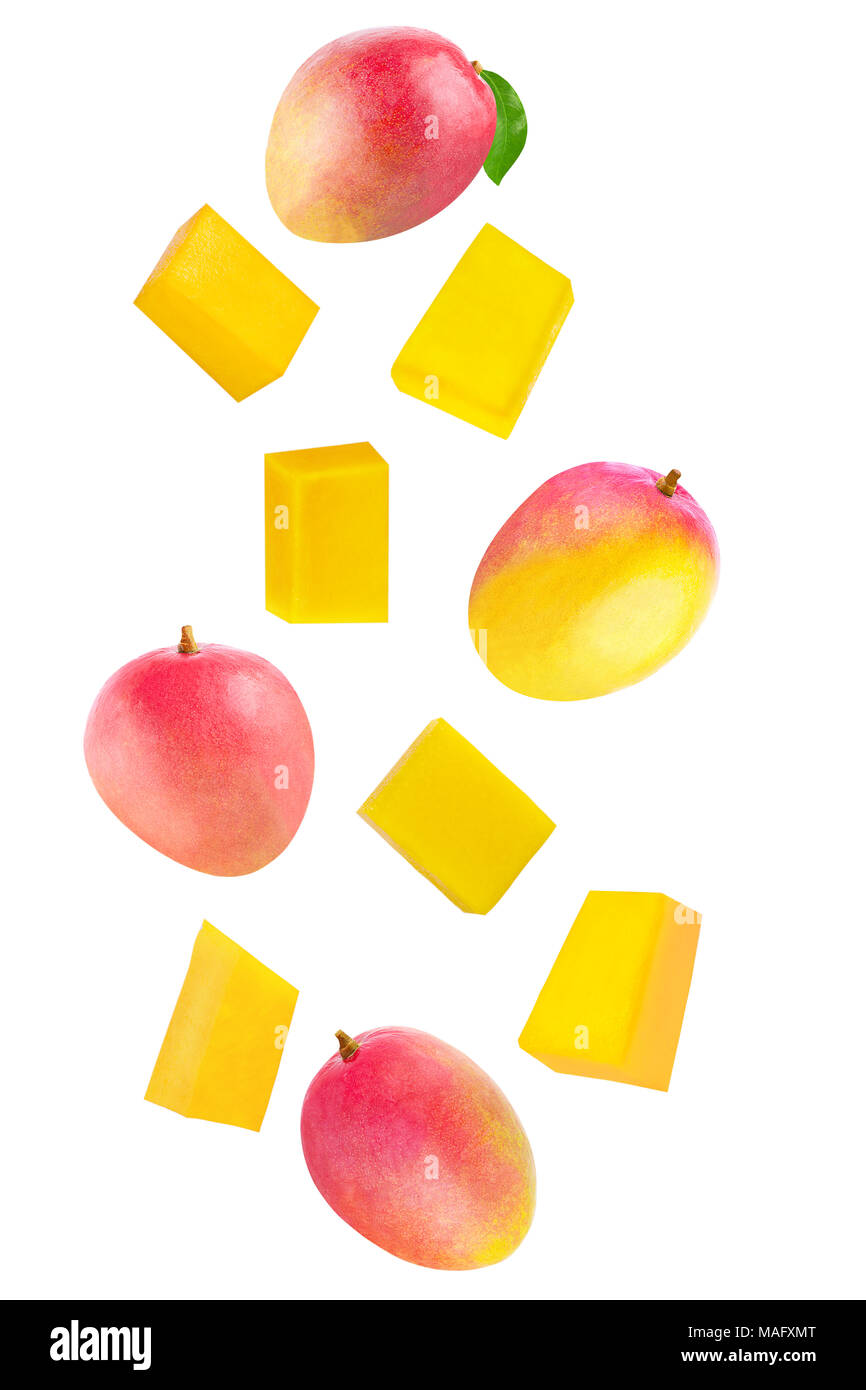 Isolated flying fruits. Whole and cubes falling mango fruit isolated on ...
