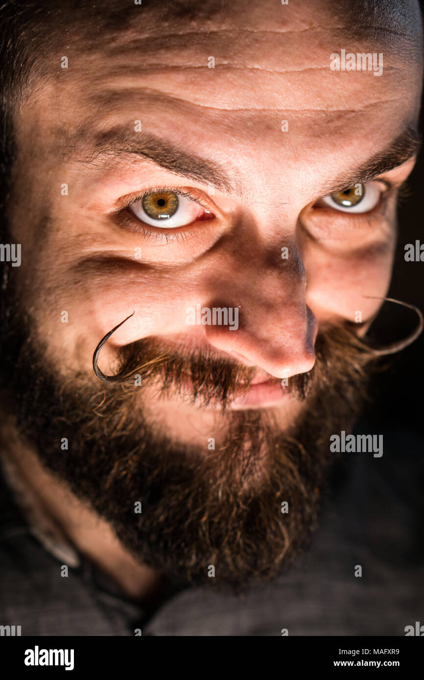 Inventor Hipster with Beard and Mustages in the Dark Room. Smiling ...