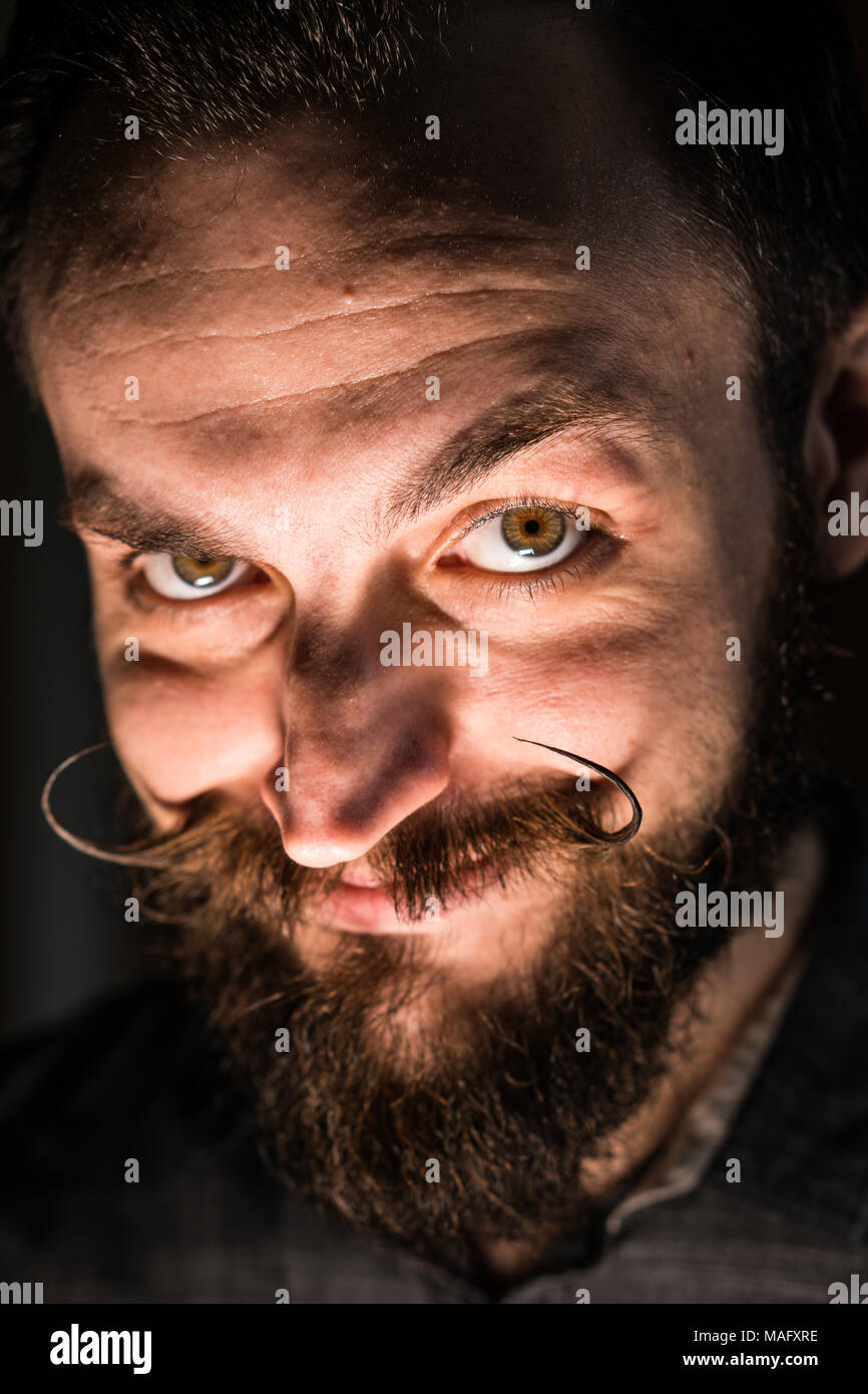 Inventor Hipster with Beard and Mustages in the Dark Room. Smiling ...
