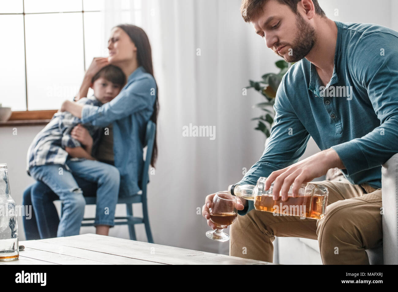 Mother father and son social problems alcoholism man pouring whiskey ...