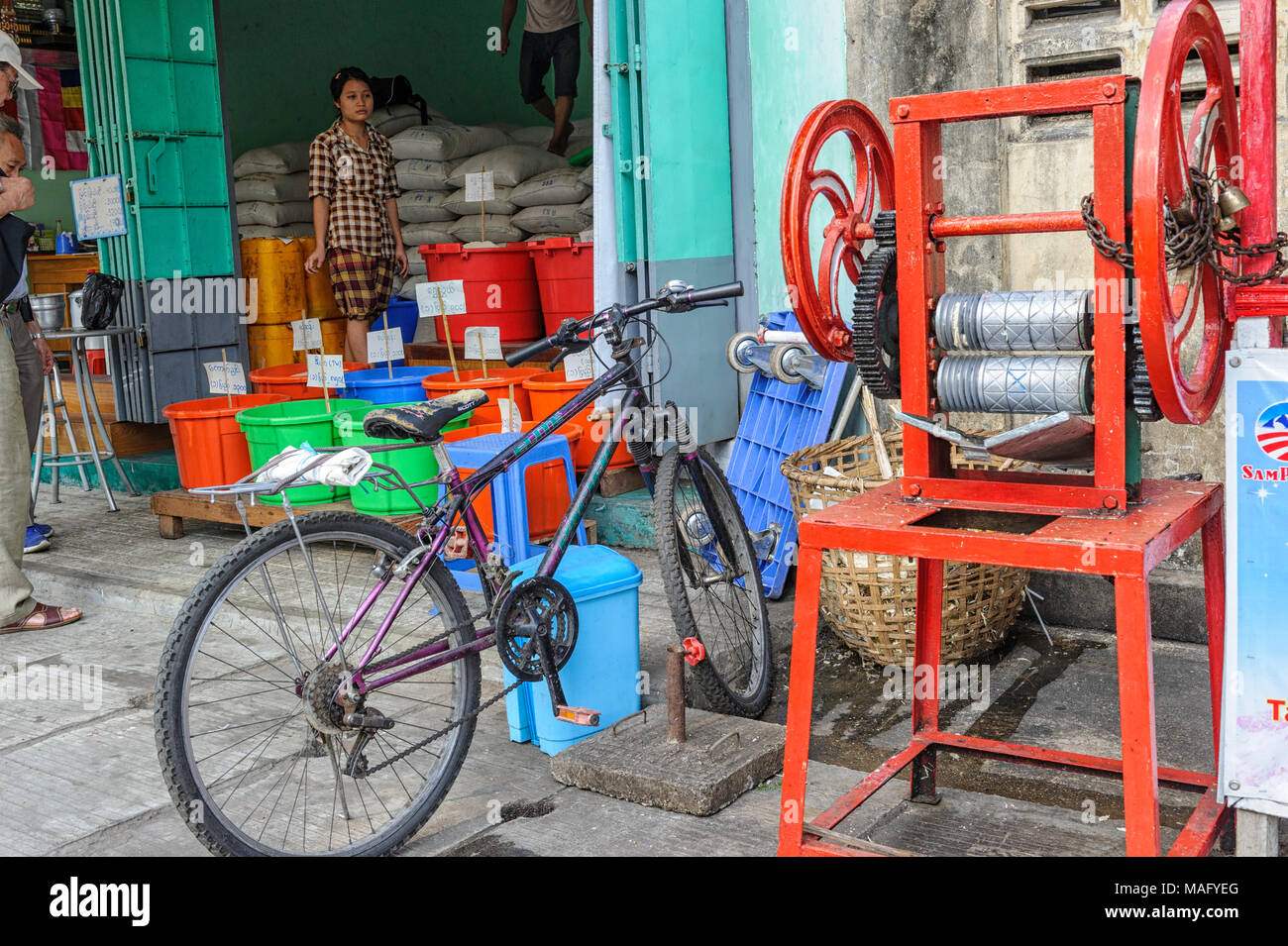 Bicycle and sugar cane press machine on the streets of Yangon, Myanmar ...