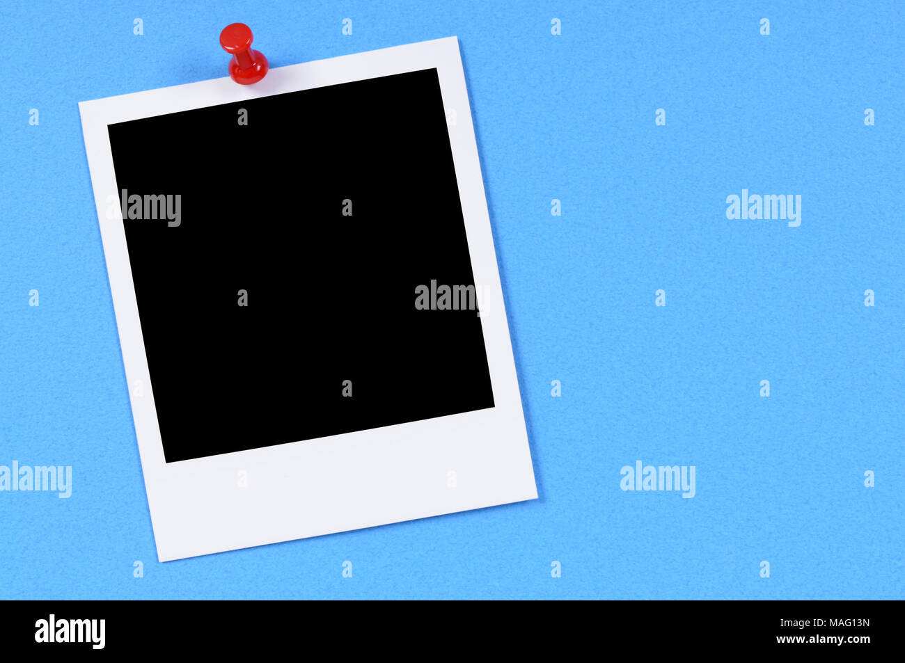 Blank photo print pinned to blue paper Stock Photo - Alamy