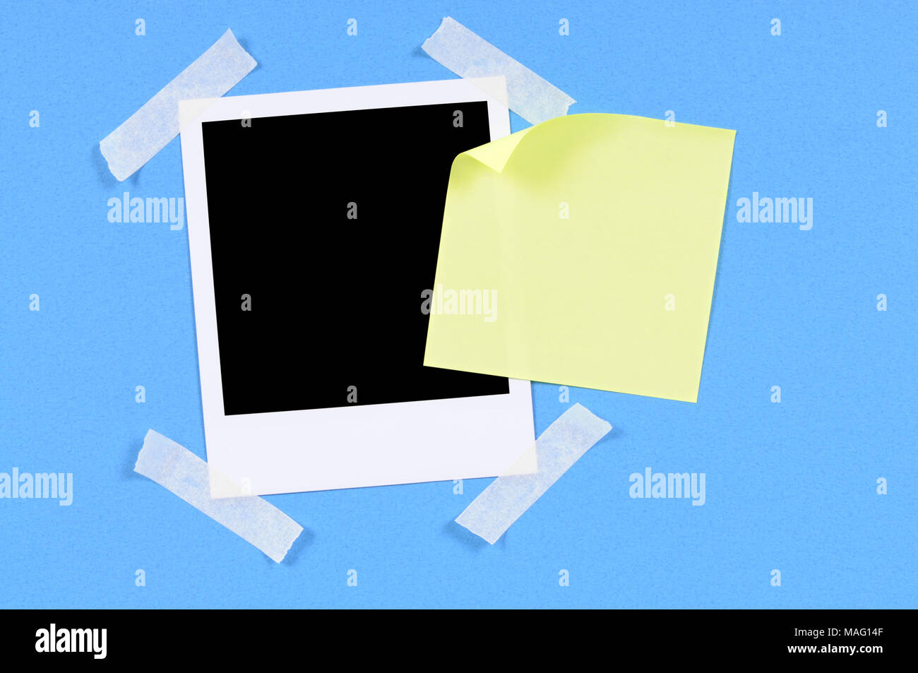 Blank photo print with yellow sticky note taped to blue paper Stock ...