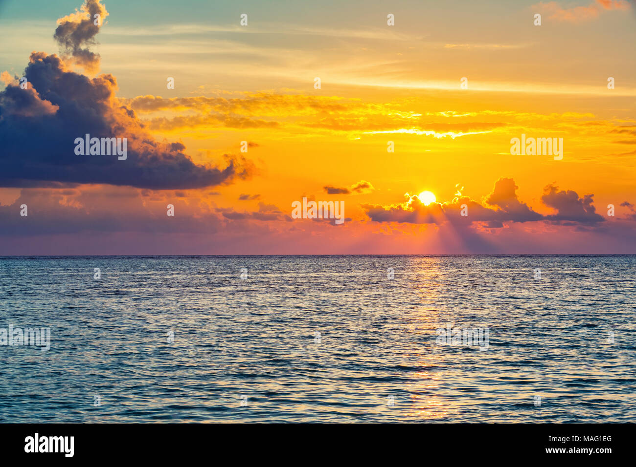 Bright sunset over ocean Stock Photo - Alamy