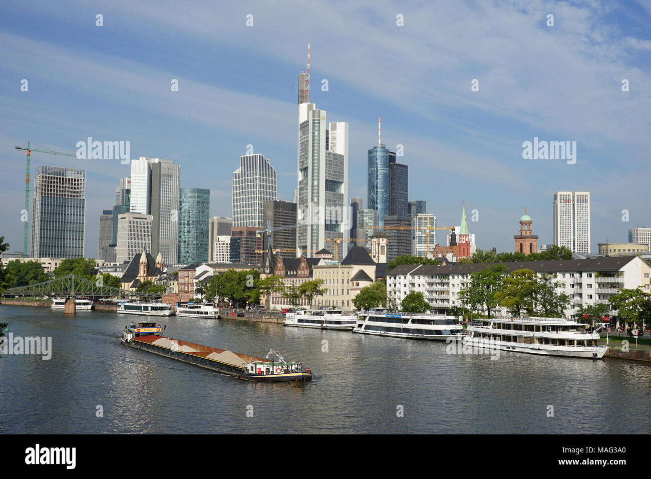Freighter floating down the Main River, famous Frankfurt Skyline ...