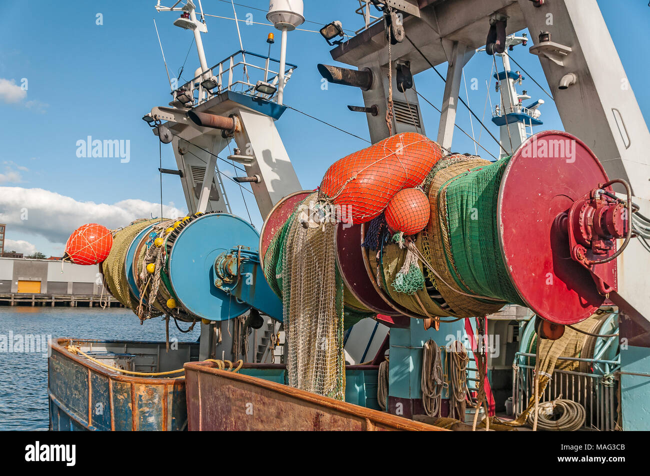 stern of a fishing boat with pulleys where fishing nets are rolled up ...
