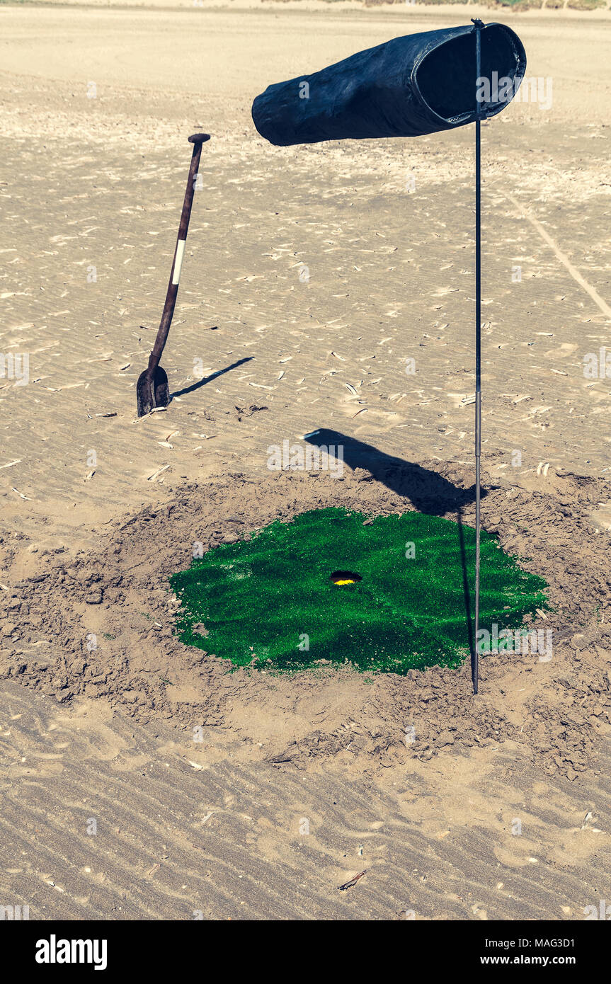 a shovel a golf hole and an anemometer on the beach Stock Photo - Alamy