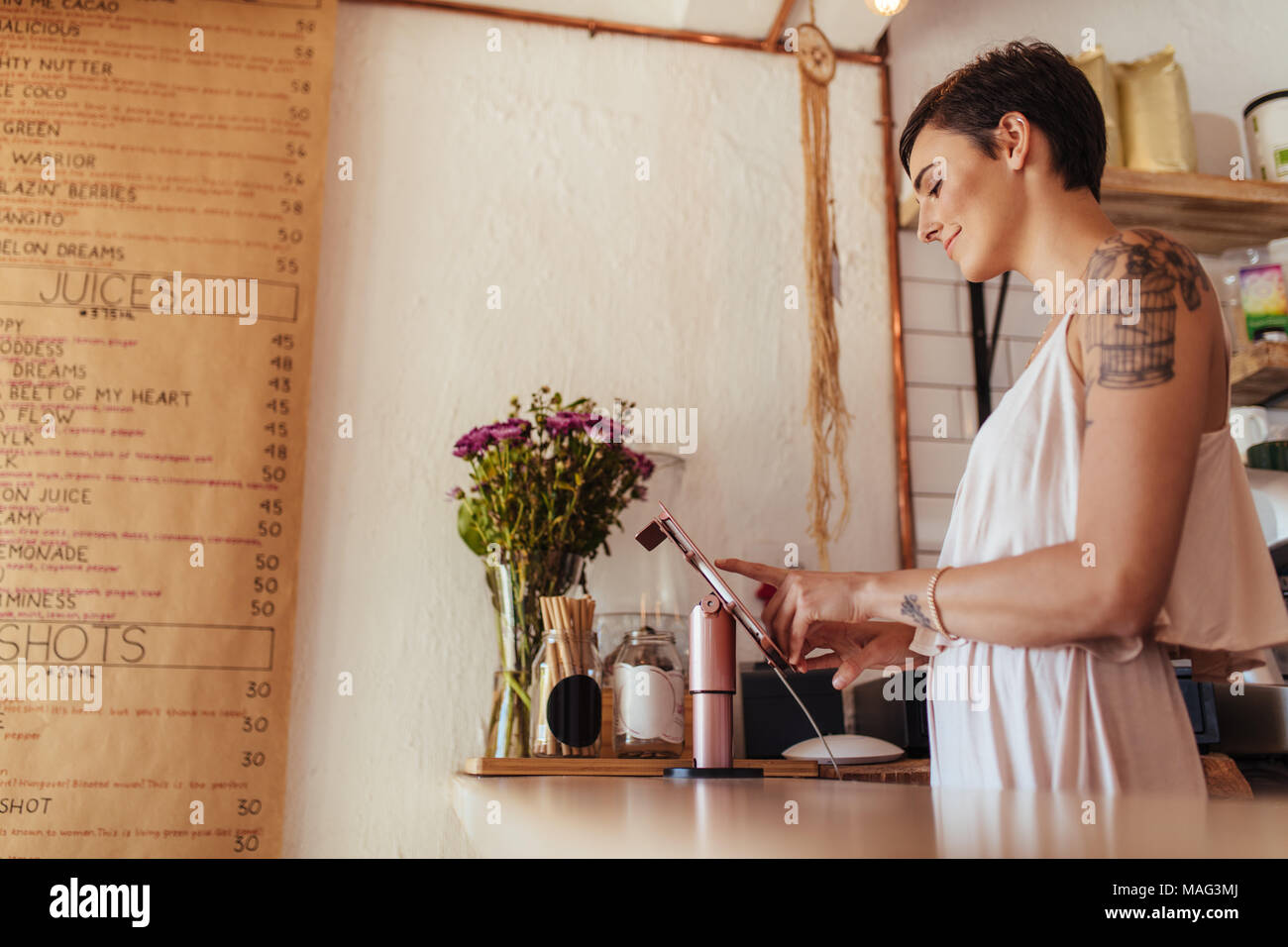 Woman standing at the billing counter of her restaurant. Restaurant ...