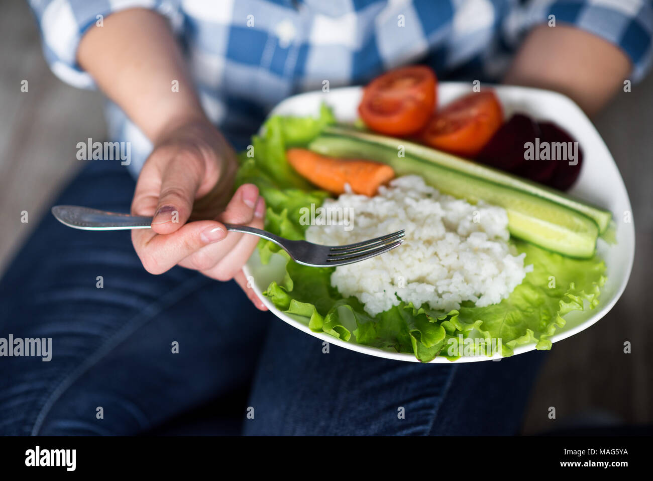 Girl with a plate of vegetables in hands Stock Photo - Alamy