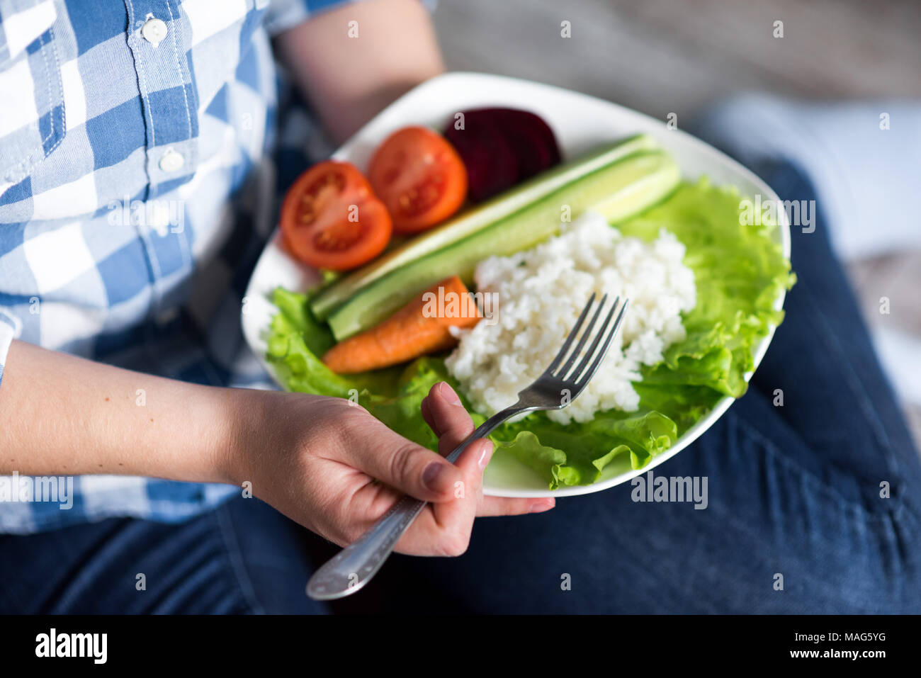 Girl with a plate of vegetables in hands Stock Photo - Alamy