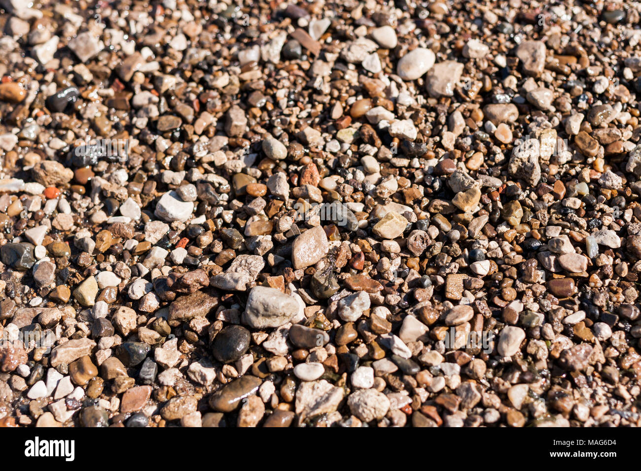 Natural background from the shallow sea stones Stock Photo - Alamy