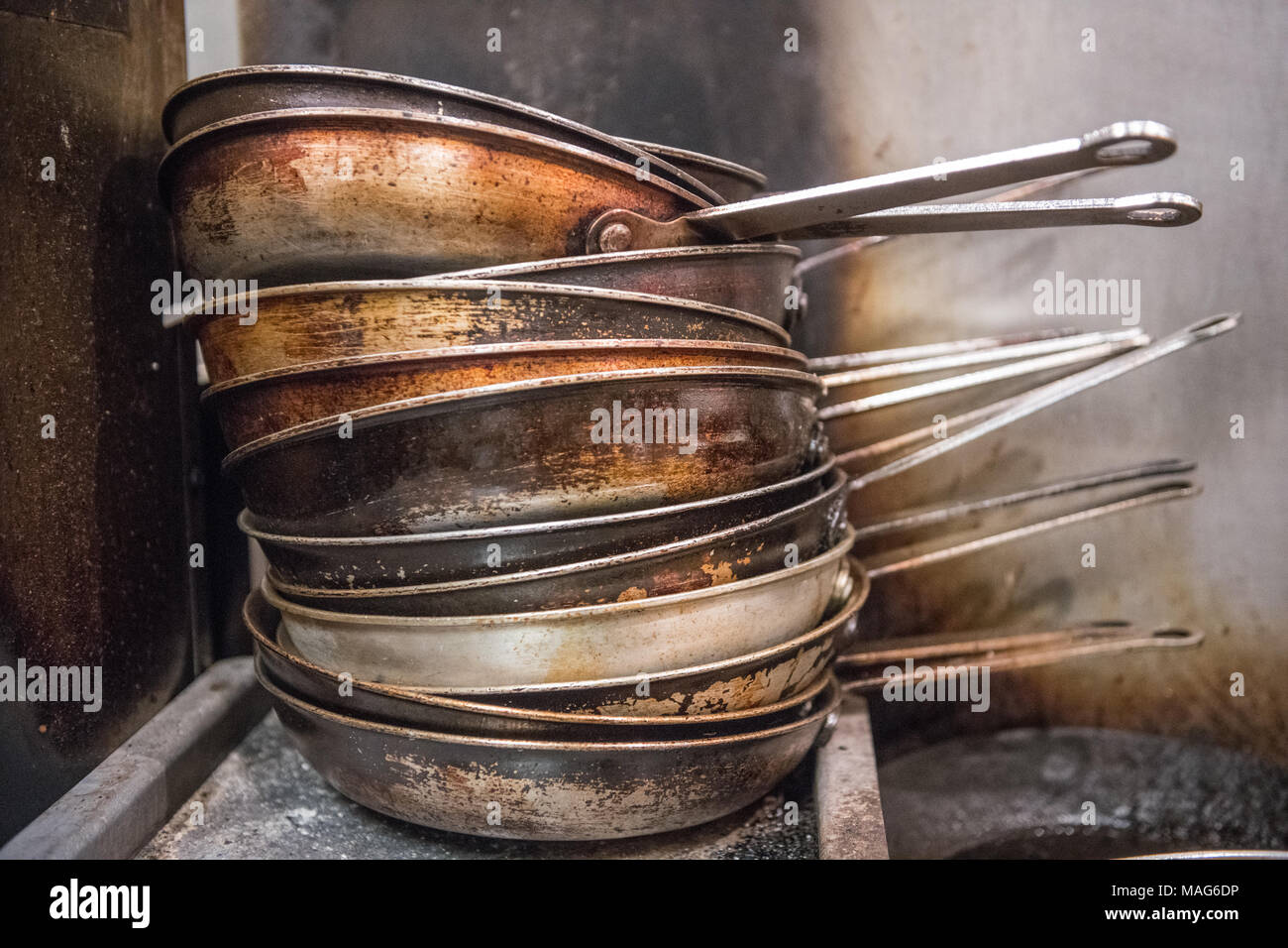 Stack of dirty pans in a commercial kitchen Stock Photo - Alamy