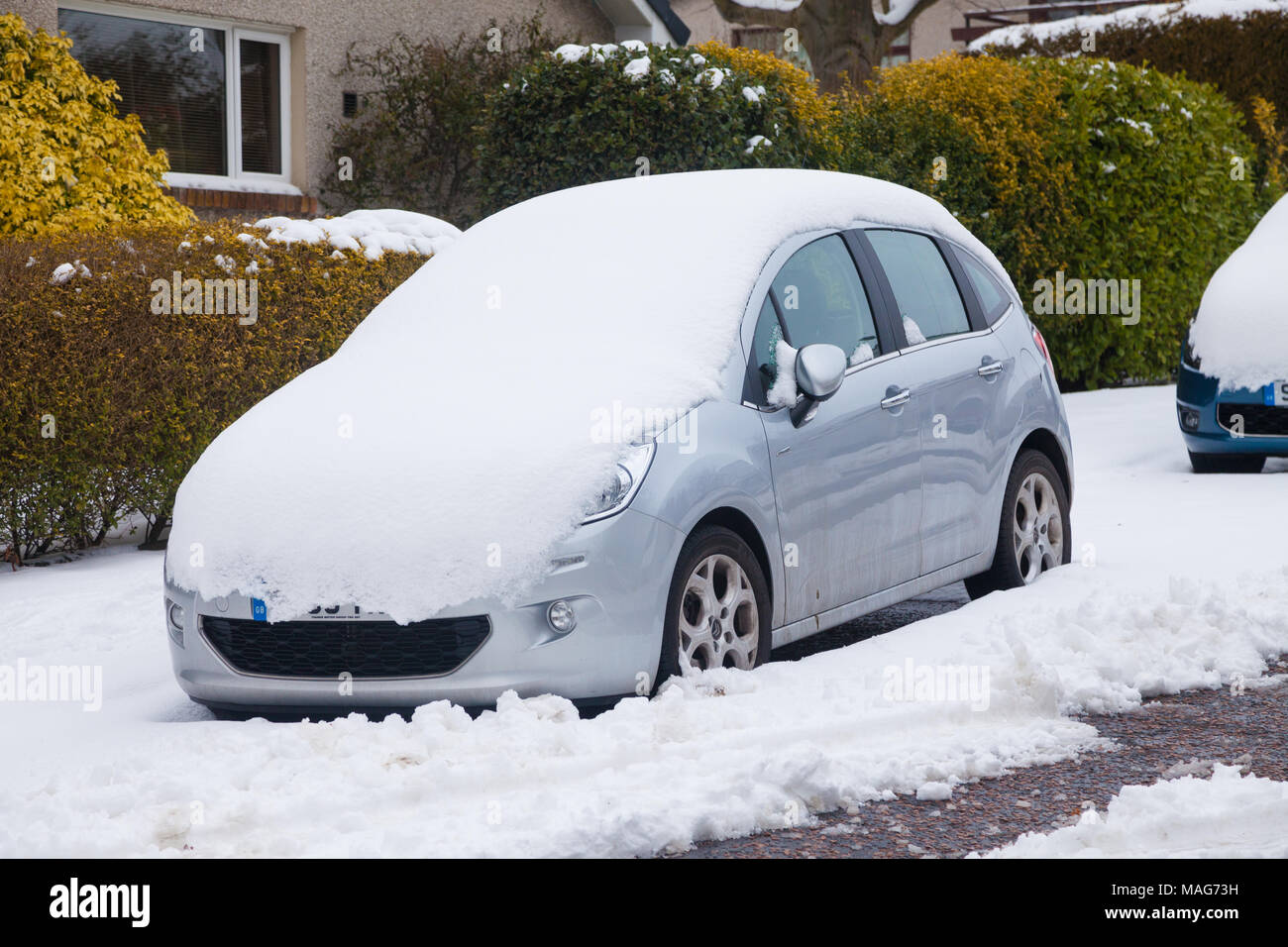 A car in Fife with a covering of snow over the windscreen and bonnet ...