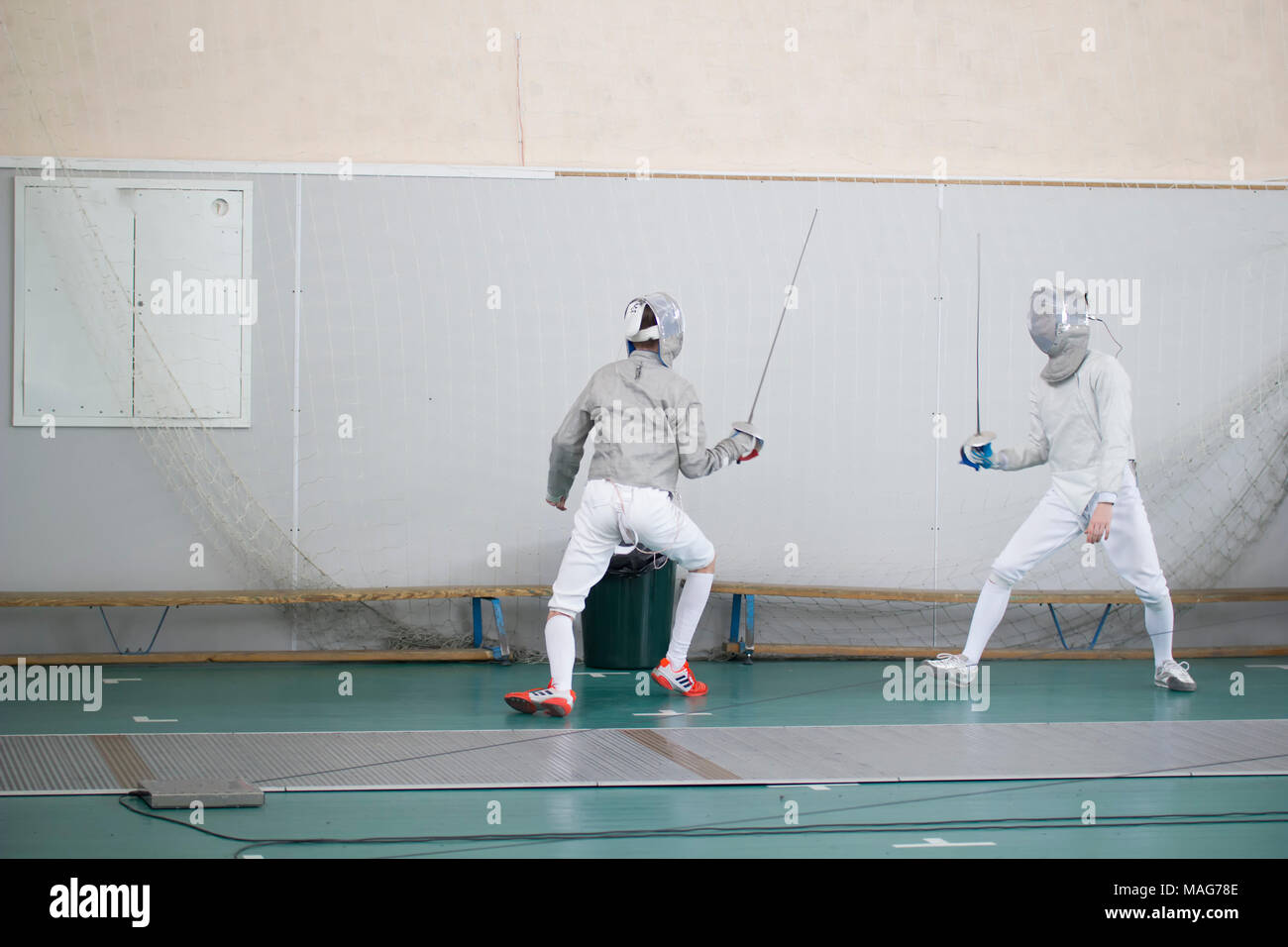 Two teenager fencers practicing their fighting with swords Stock Photo ...