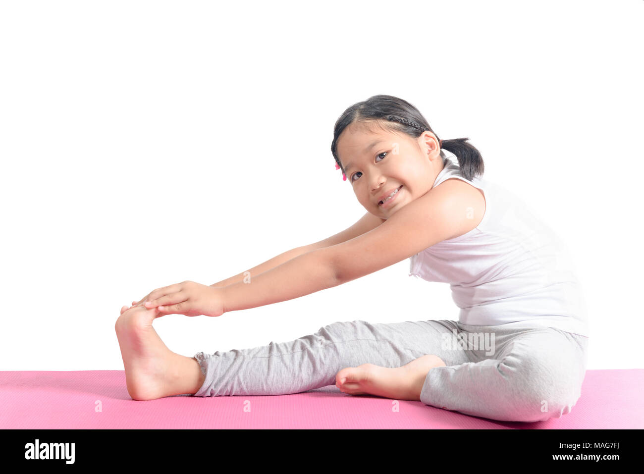 Haealthy asian kid exercise on yoga mat isolated on white background ...