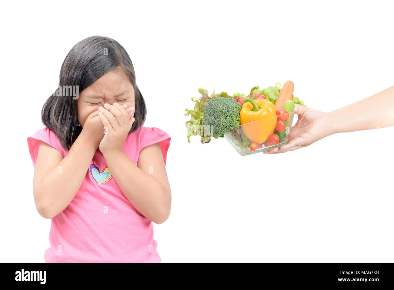 asian child girl with expression of disgust against vegetables isolated ...