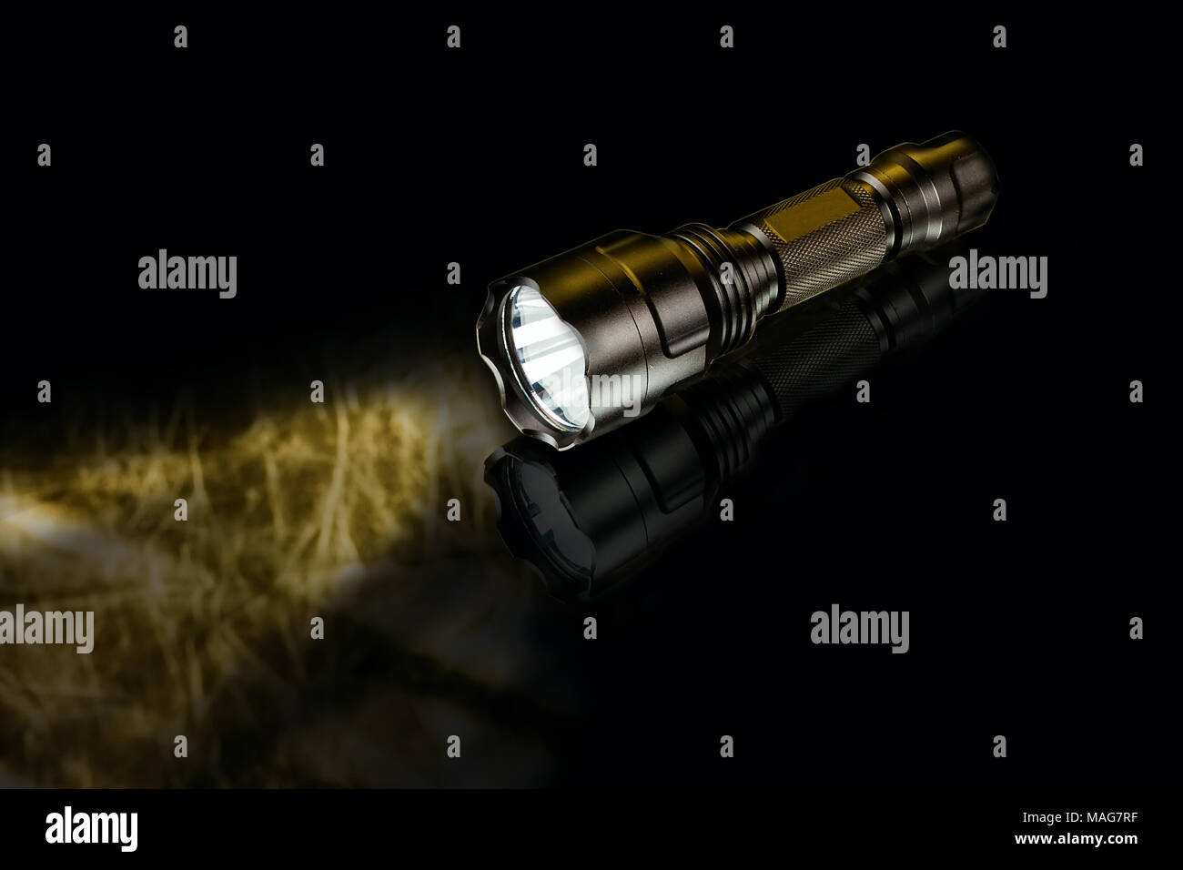 black anodized aluminium waterproof tactical flashlight on dark ...