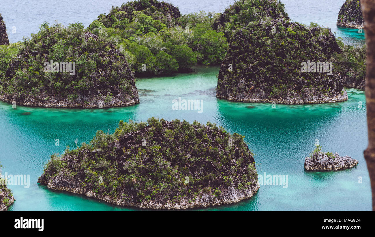 Painemo, Group of small island in shallow blue lagoon water, Raja Ampat ...