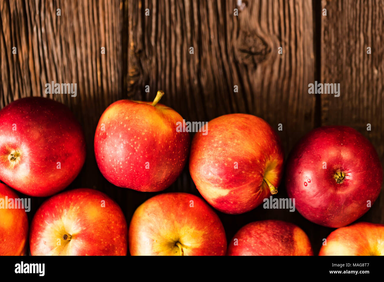Background of apples whole and cut on wood Stock Photo - Alamy