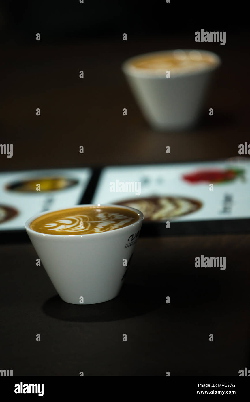 Cups of coffee and steamed milk drink, with latte-art pictures at the ...