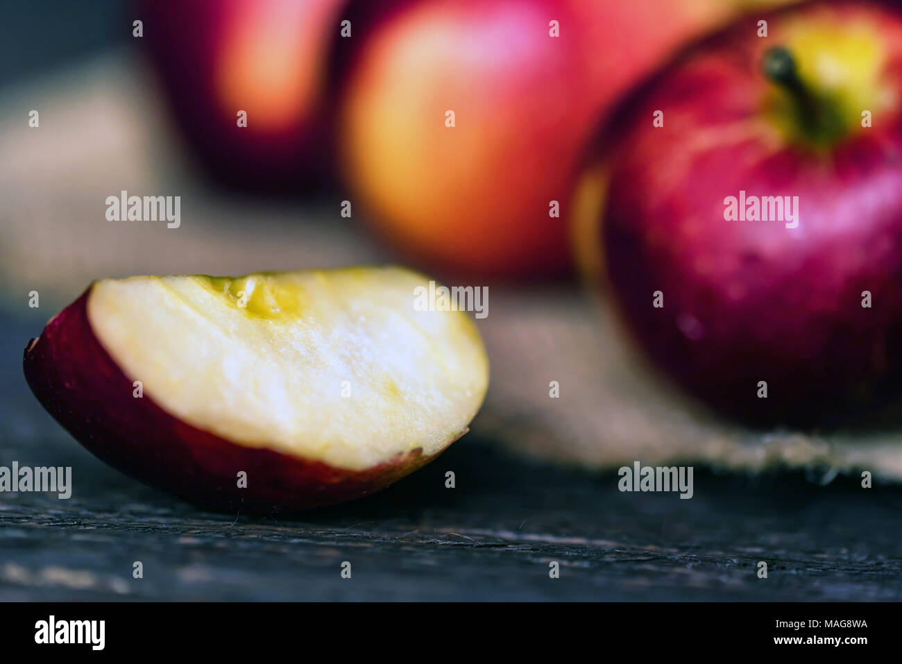 Whole and cut red apples on burlap napkin close Stock Photo - Alamy