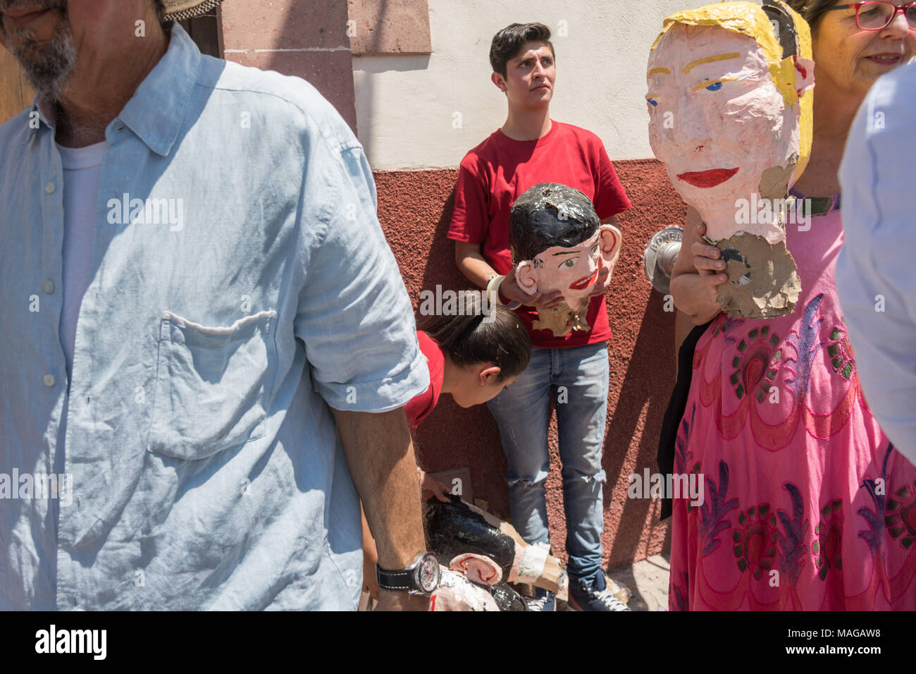 People walk away with the head of an effigy of U.S. President Donald ...