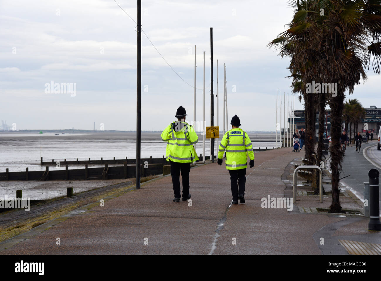 Police officers walking the beat on Southend on Sea seafront on bank ...