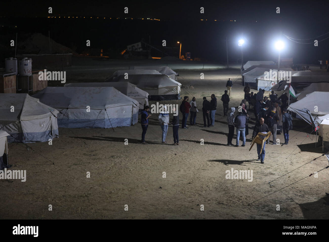 Gaza, 2 April 2018. Palestinians walk next to tents erected along the ...