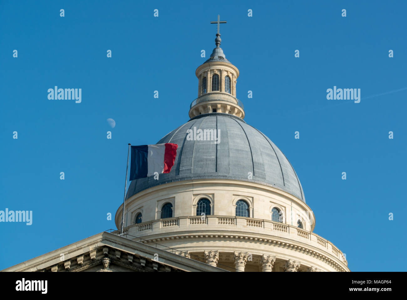 A French flag flies above The Pantheon as the moon rises in Paris ...