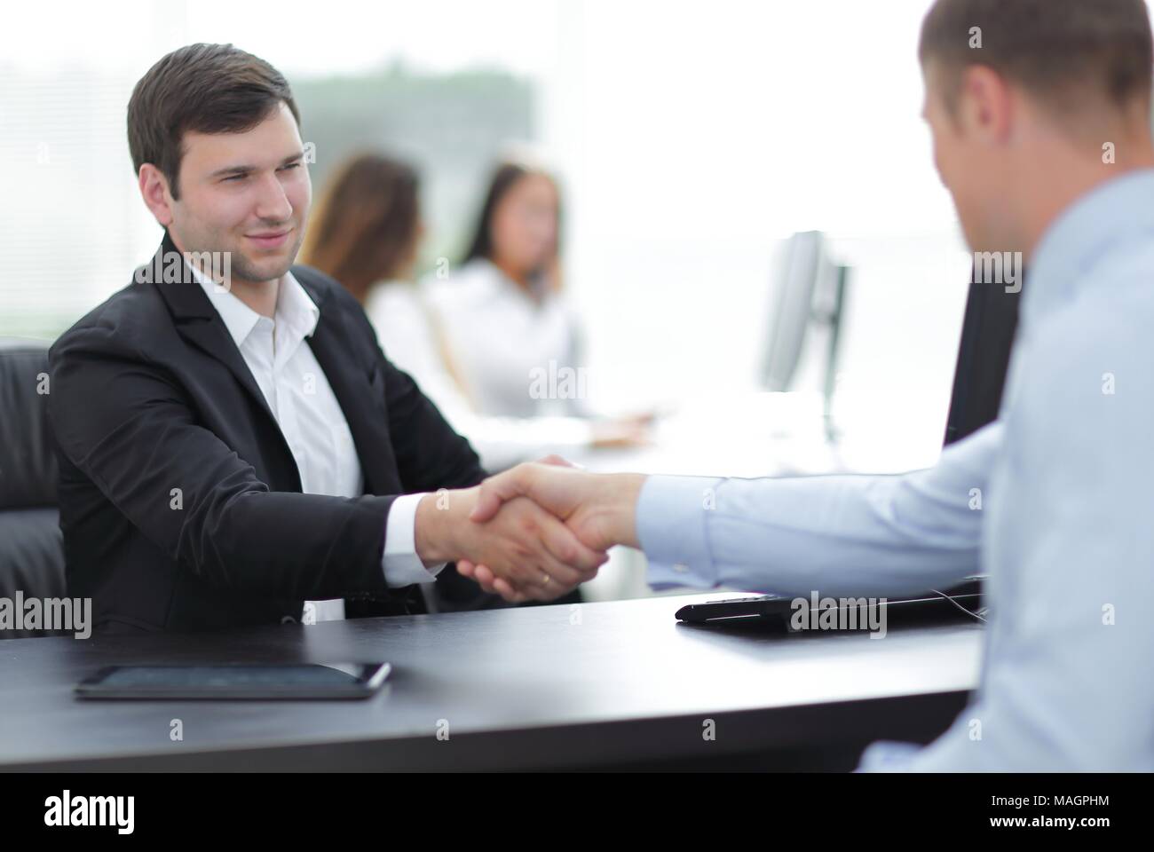 handshake business partners at your Desk Stock Photo - Alamy