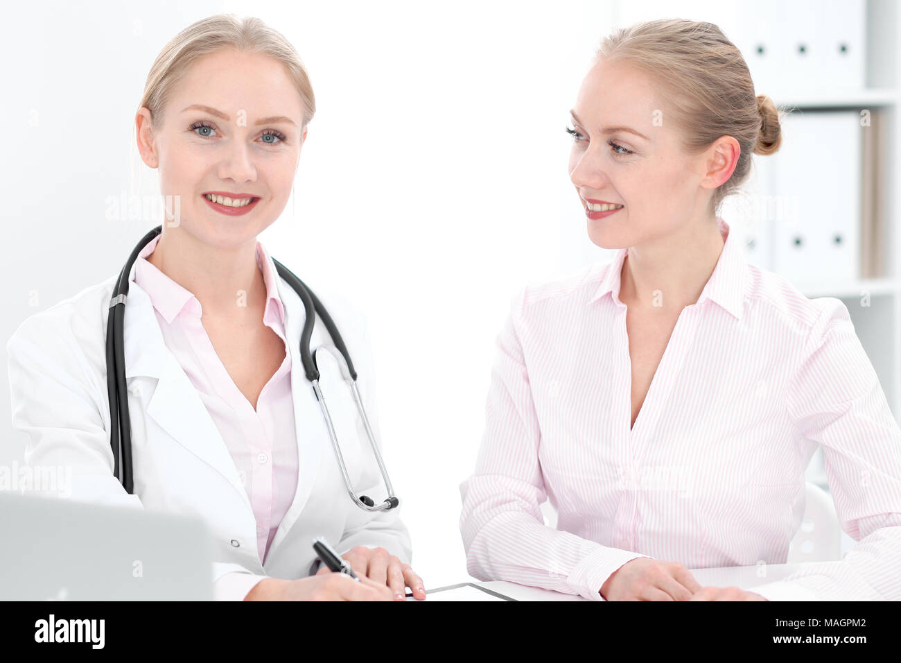 Blonde female doctor and patient during personal consulting in hospital ...